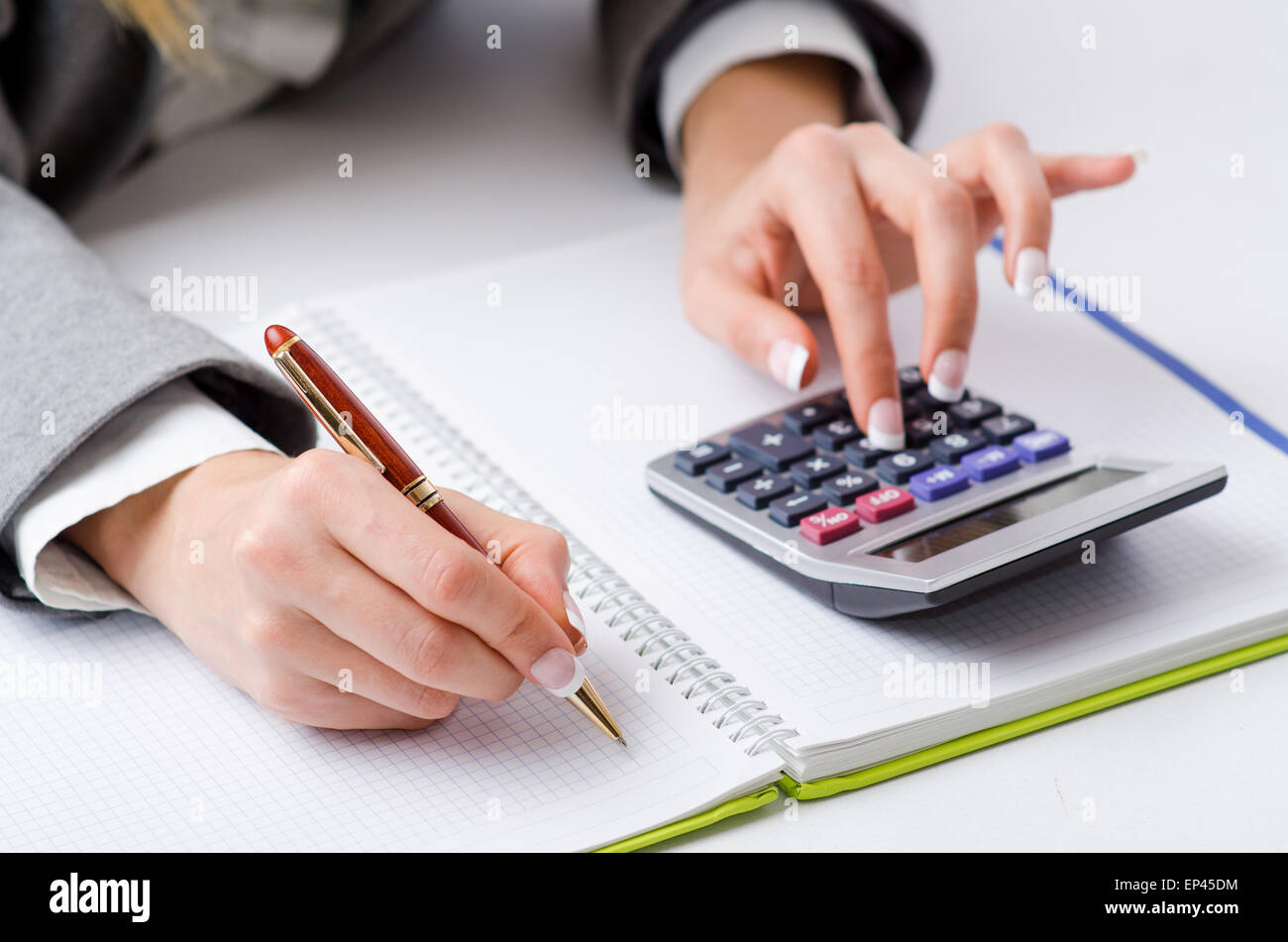 Hands working on the calculator Stock Photo - Alamy