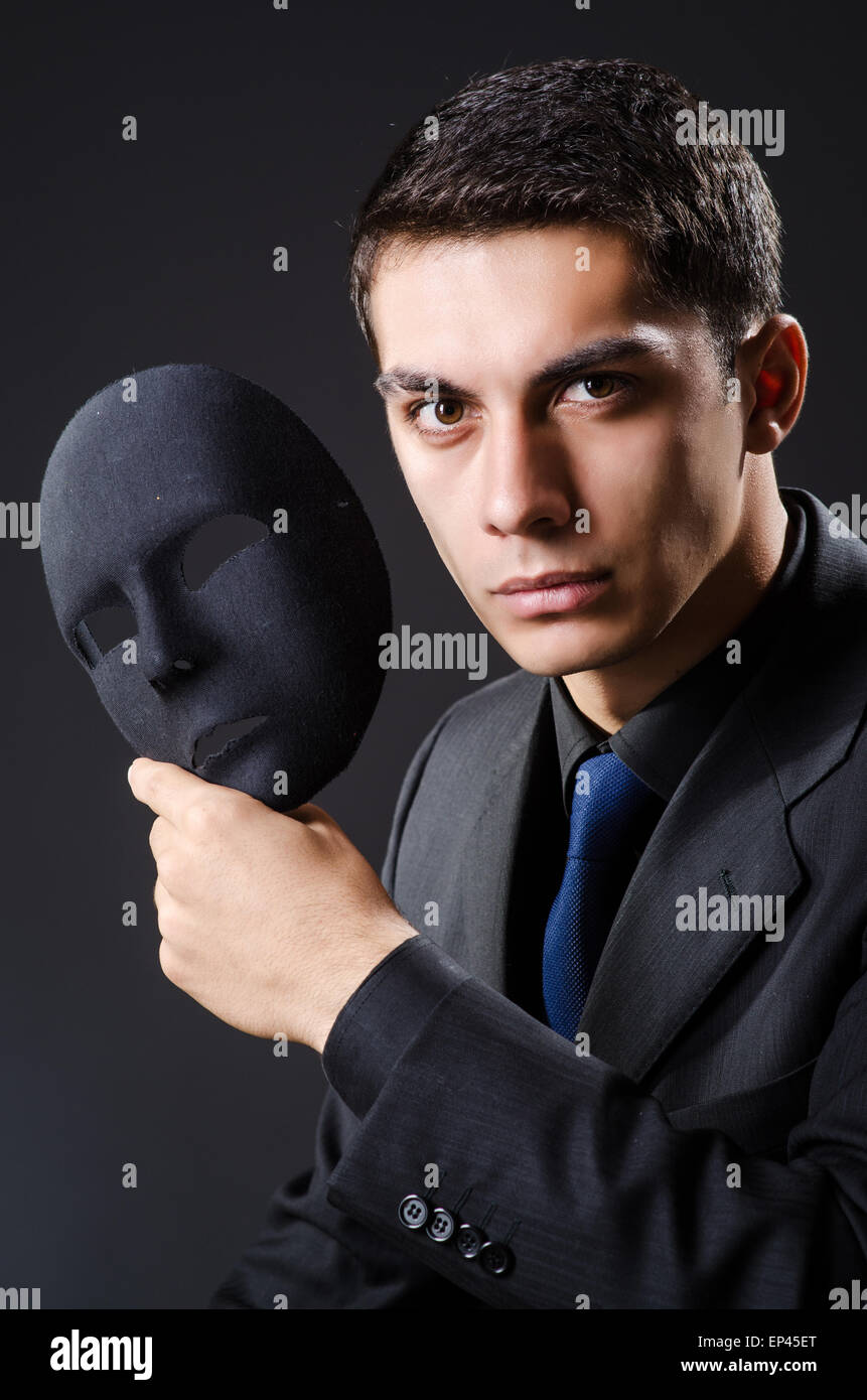 Man with mask in the dark Stock Photo - Alamy