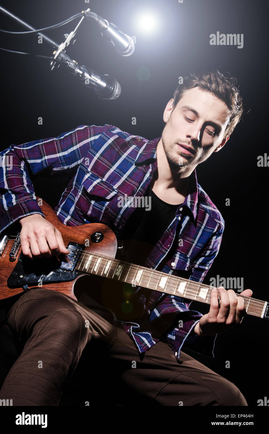 Man playing guitar during concert Stock Photo - Alamy
