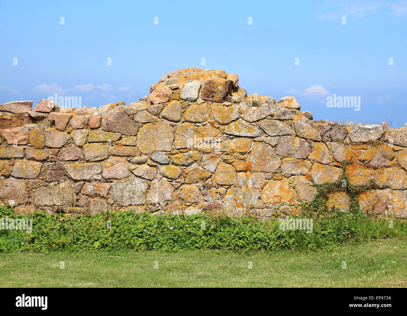 Ancient ruin wall of rocks with blue sky Stock Photo - Alamy