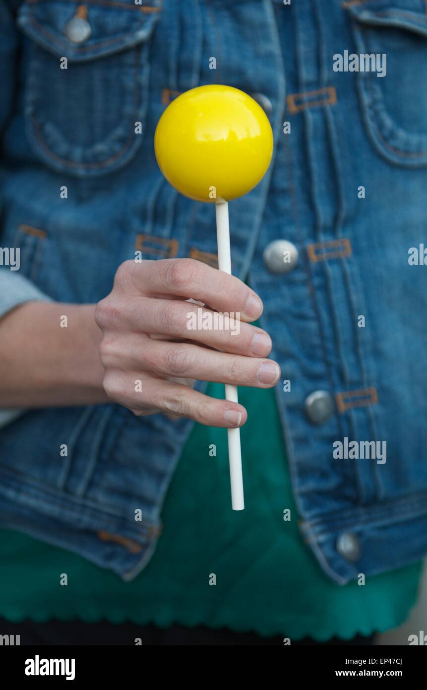 Hand holding lollipop hi-res stock photography and images - Alamy