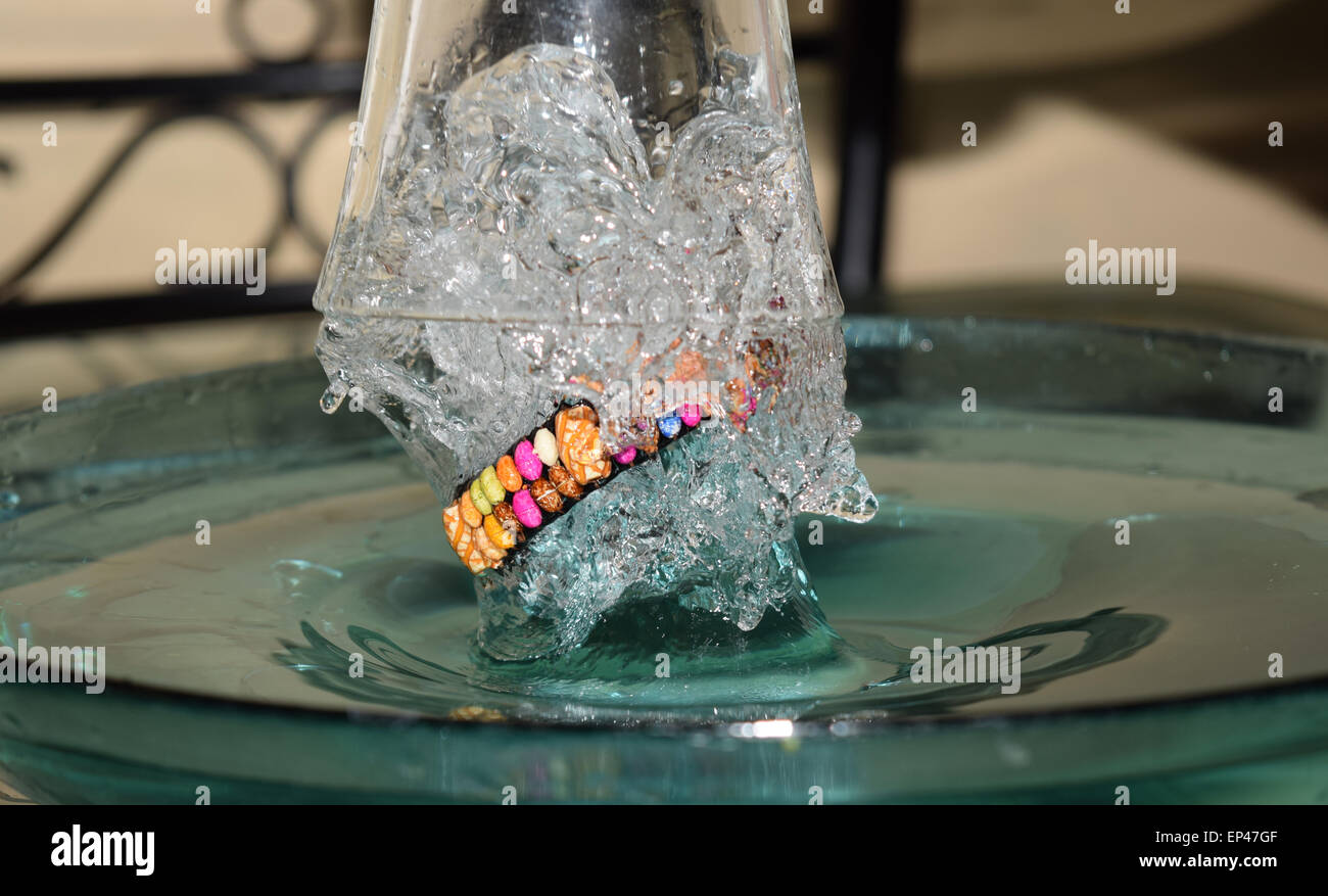 Pulling a glass from water base create a majestic image of water splash ...