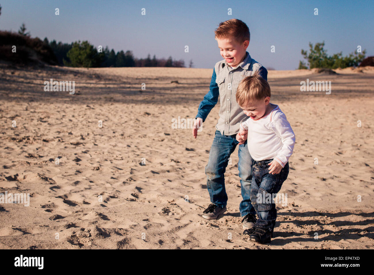 Two boys playing on the beach Stock Photo - Alamy