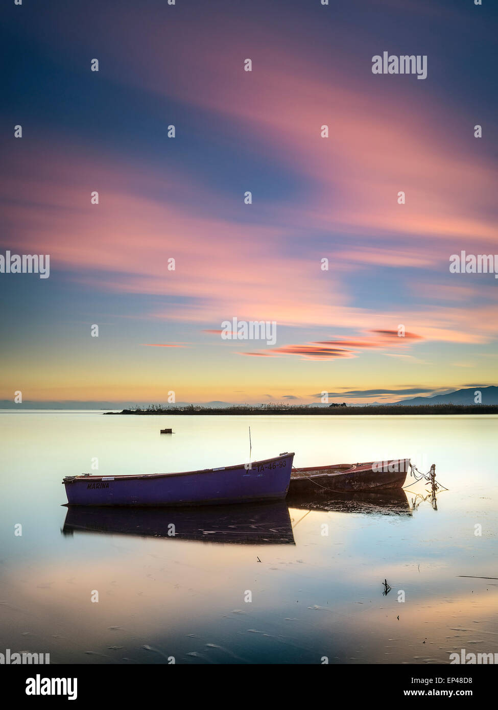 Two boats in a bay at sunset Stock Photo - Alamy