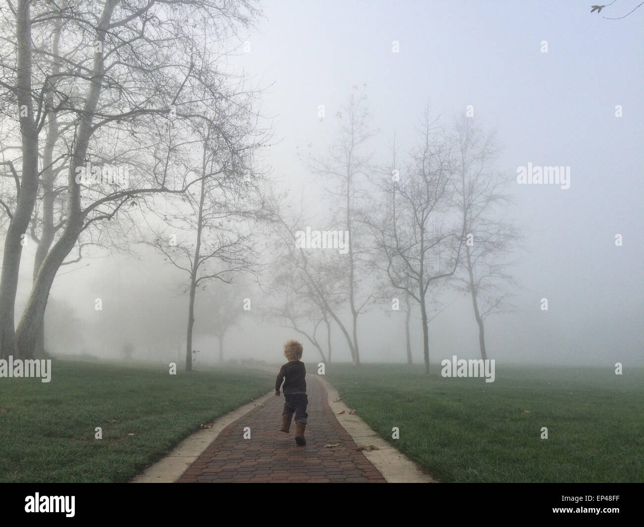 Boy running down path Stock Photo - Alamy