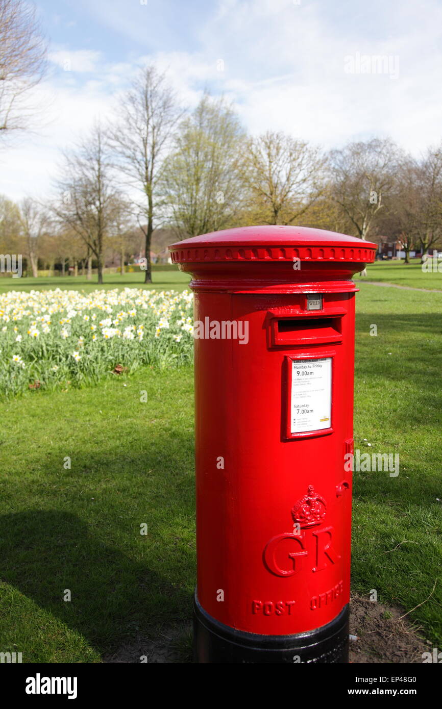 Red post box in a park Stock Photo - Alamy