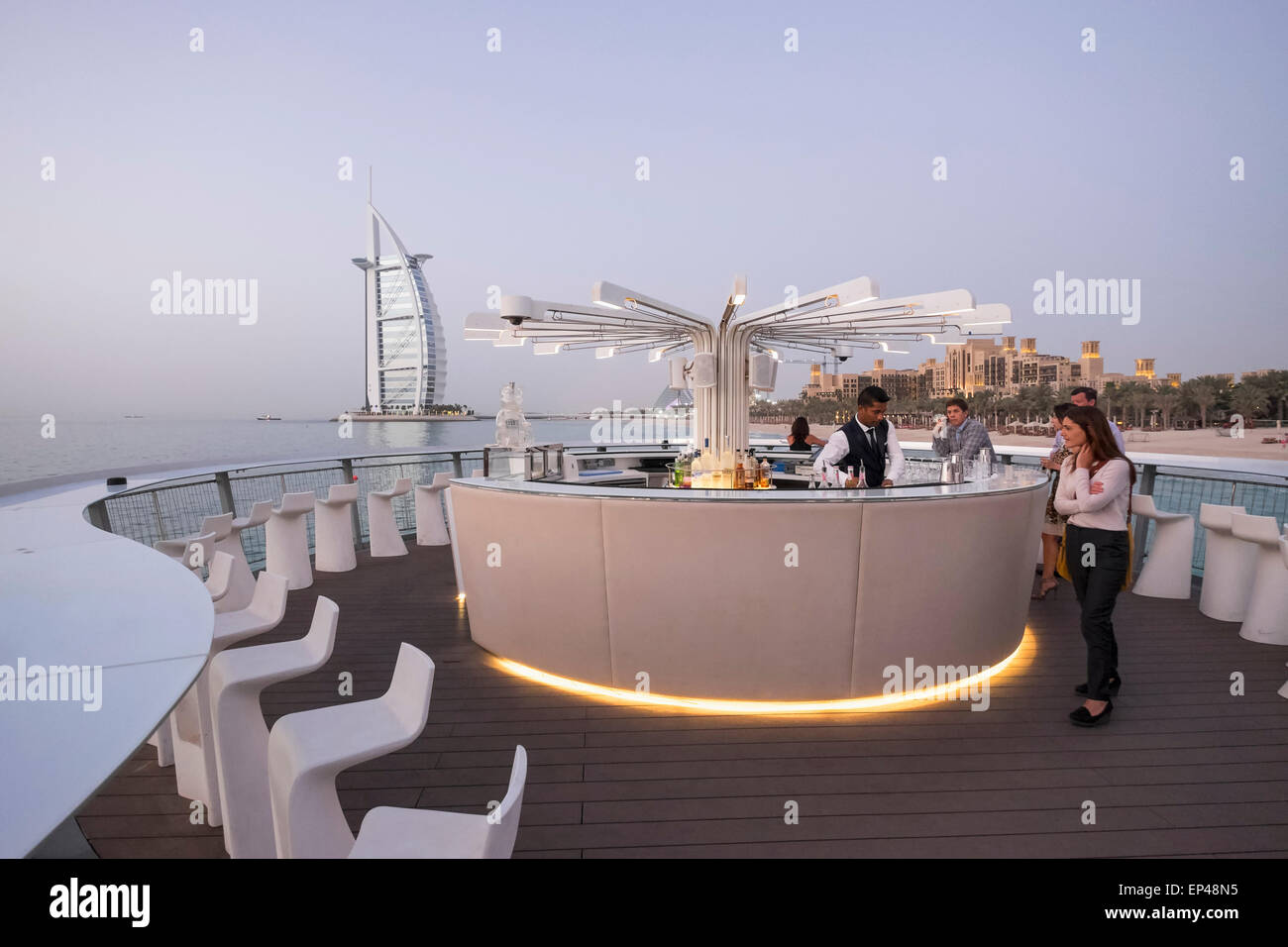 Outdoor bar on pier in evening at Pierchic restaurant at Al Qasr Hotel ...