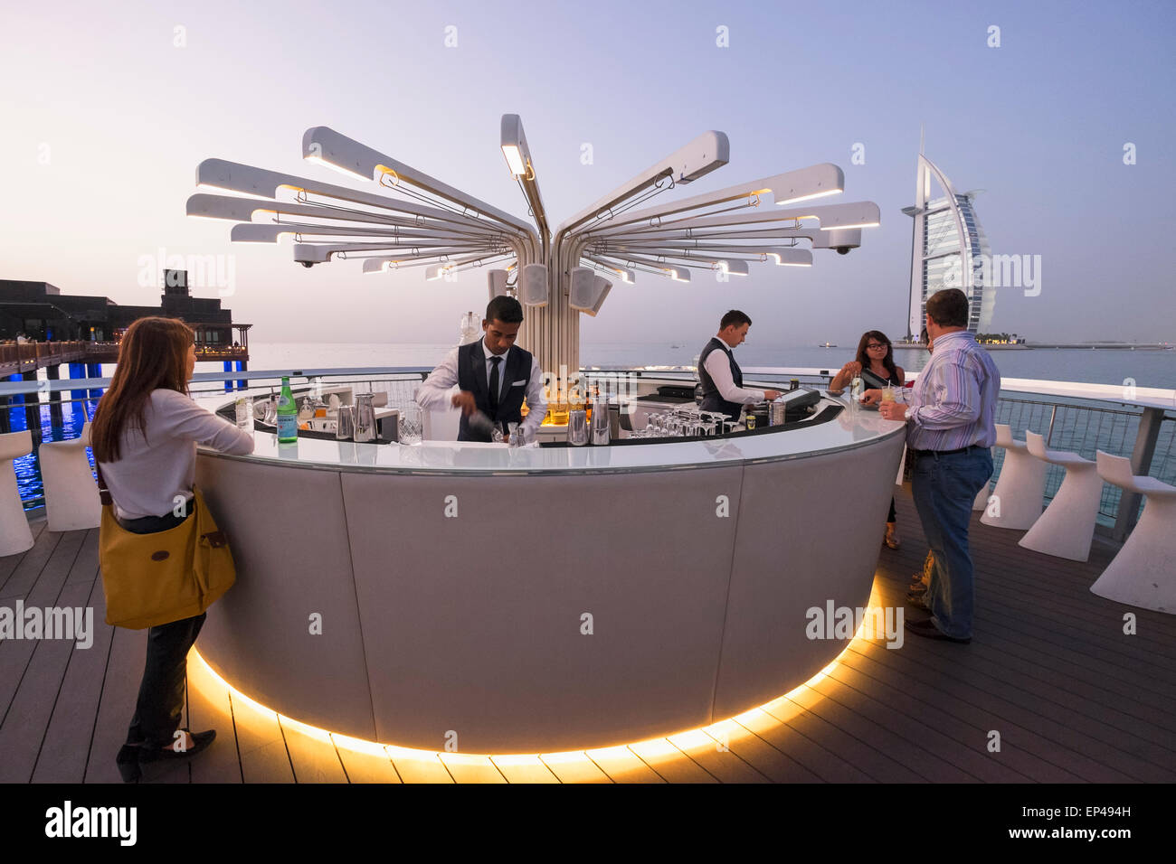 Outdoor bar on pier in evening at Pierchic restaurant at Al Qasr Hotel ...