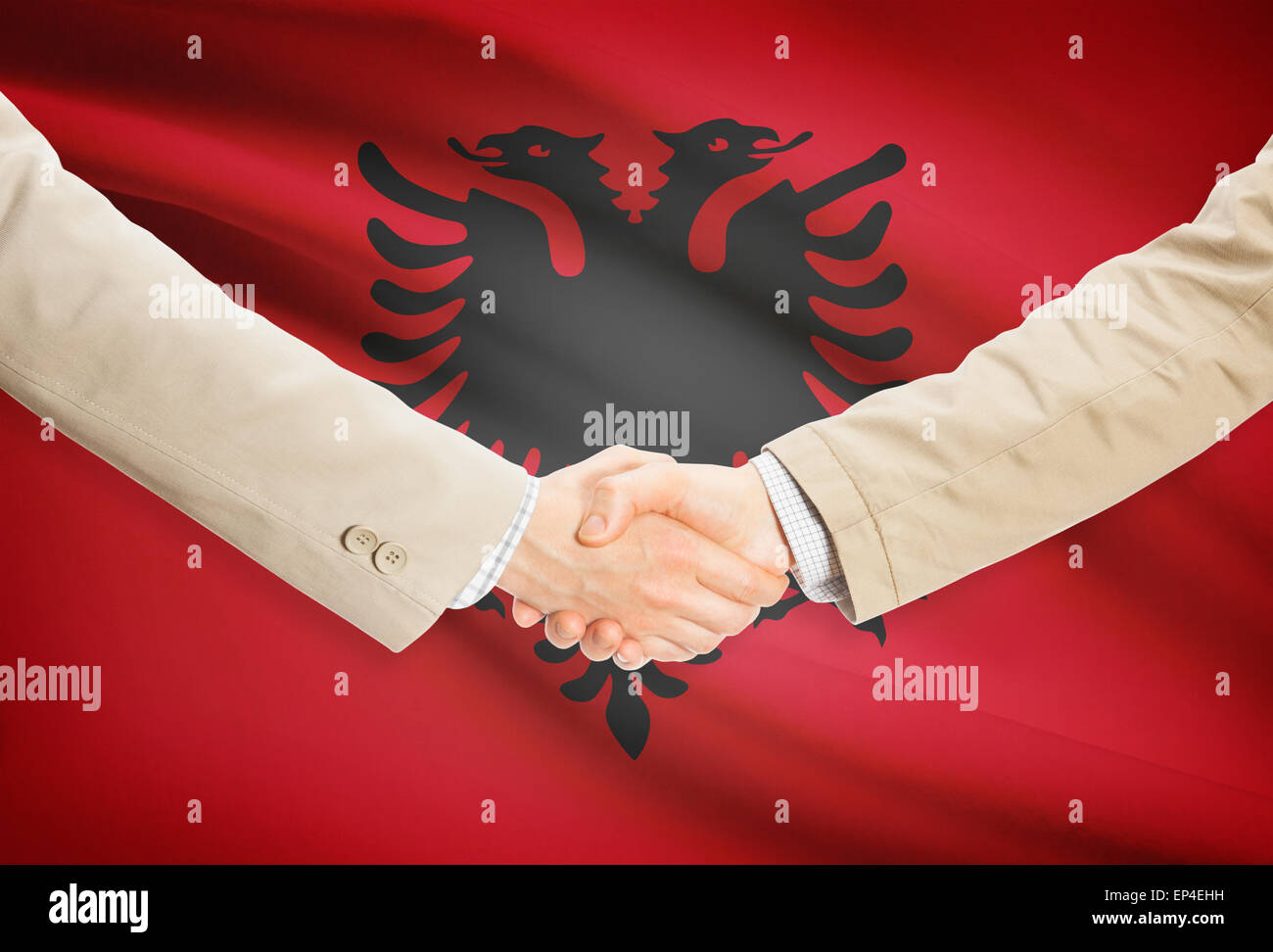 Businessmen shaking hands with flag on background - Albania Stock Photo ...
