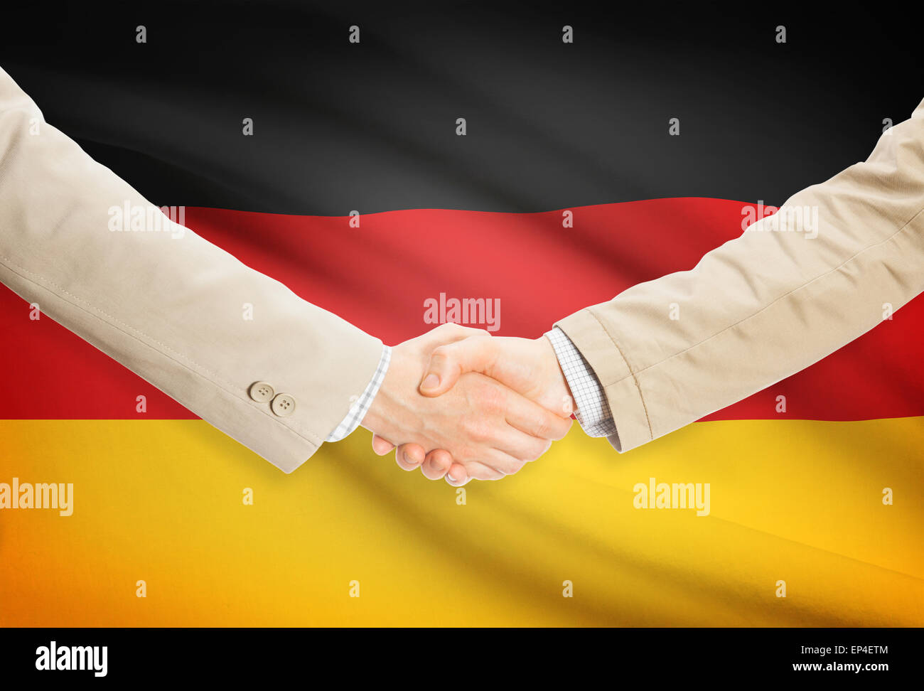 Businessmen shaking hands with flag on background - Germany Stock Photo ...