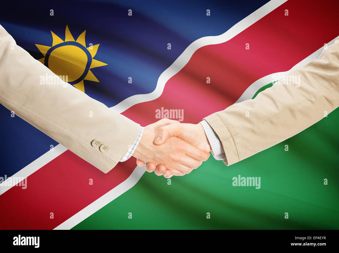 Businessmen shaking hands with flag on background - Namibia Stock Photo ...