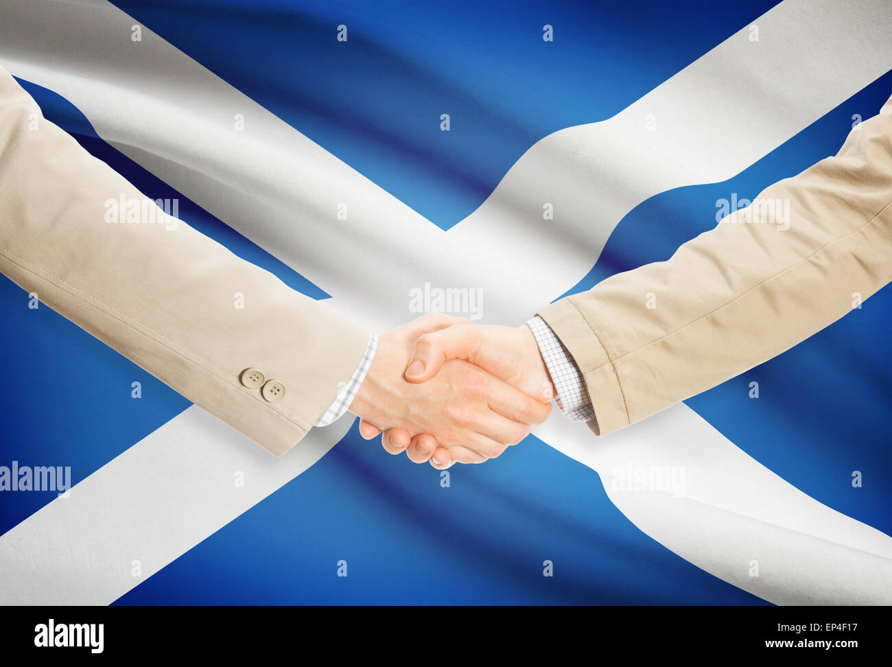 Businessmen shaking hands with flag on background - Scotland Stock ...
