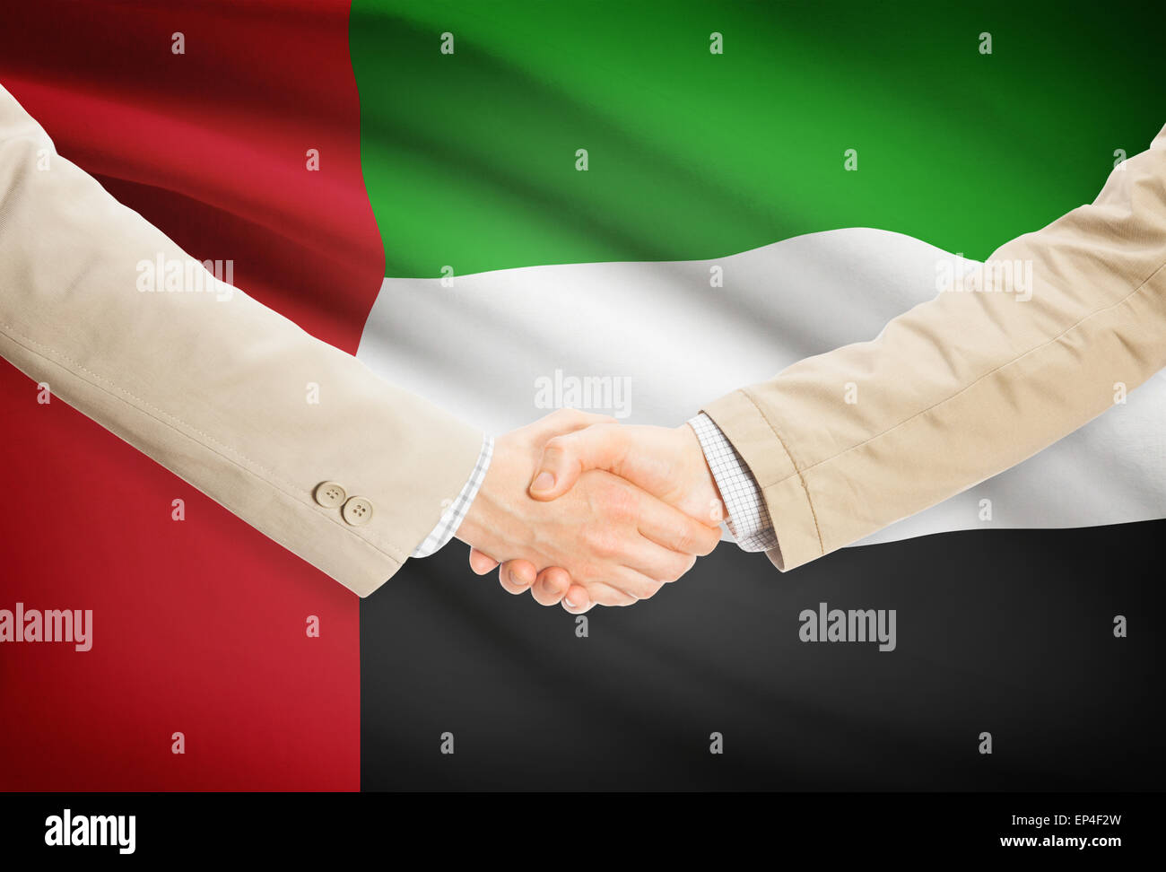 Businessmen shaking hands with flag on background - United Arab ...