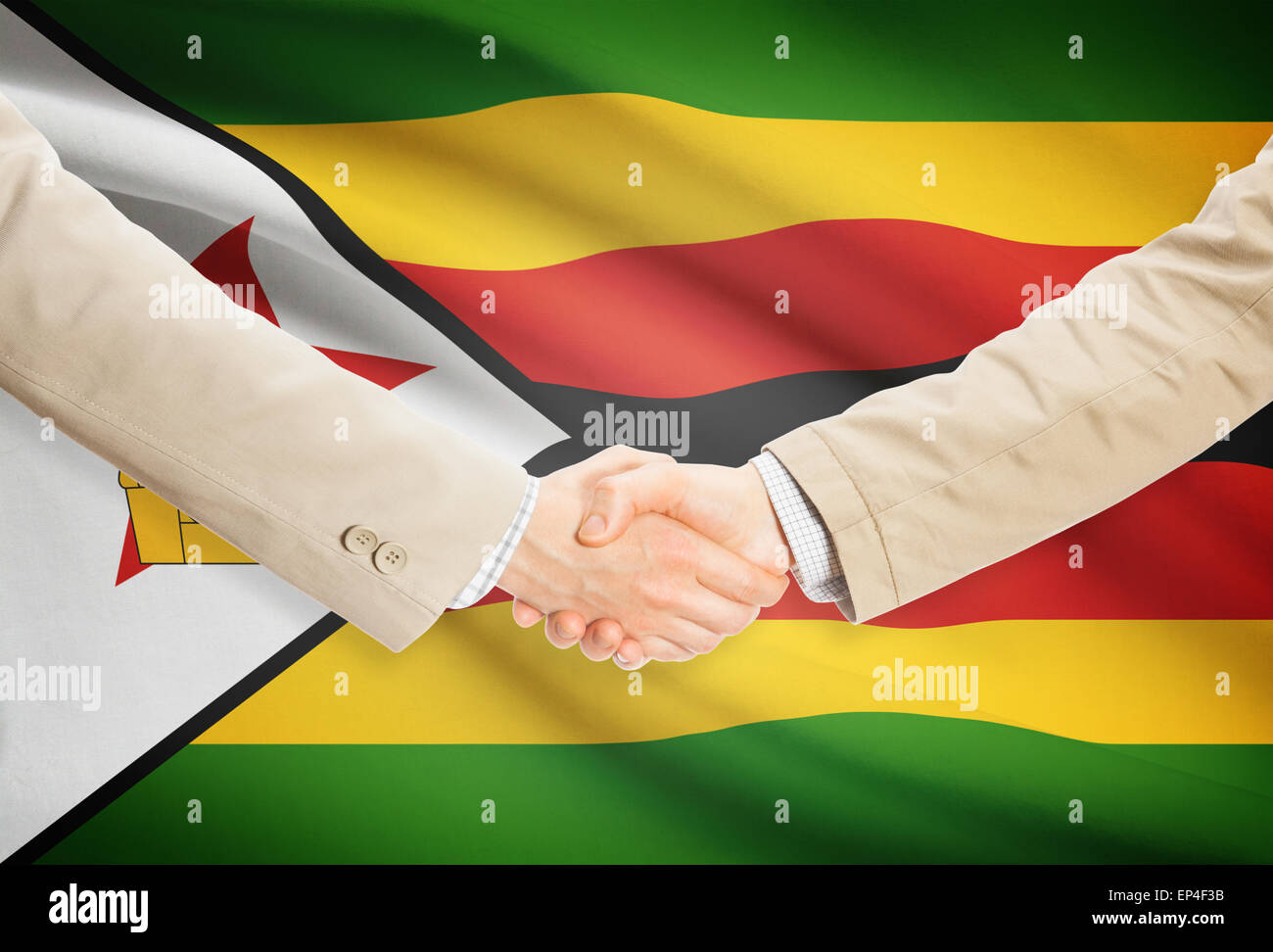 Businessmen shaking hands with flag on background - Zimbabwe Stock ...