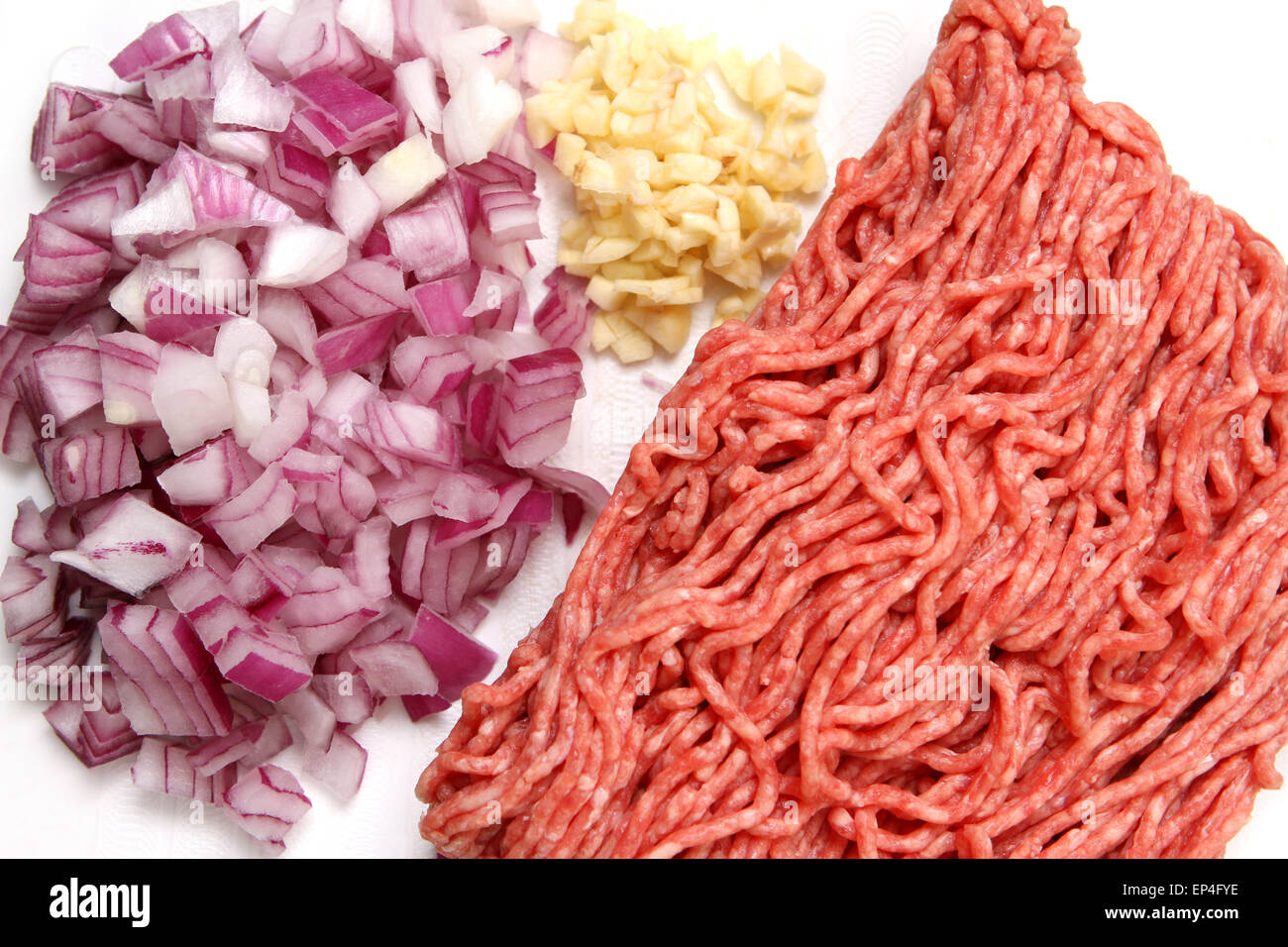Minced meat (ground beef) with onion and garlic on chopping board Stock ...