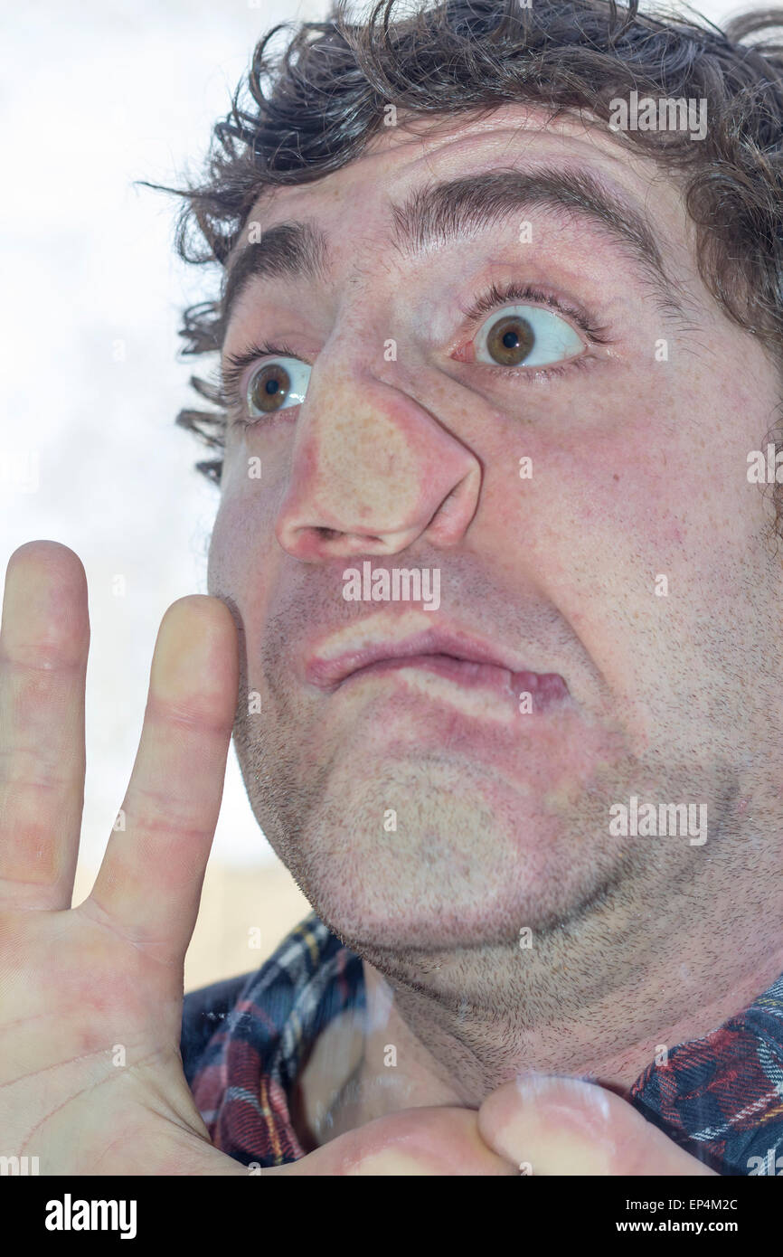 Crazy lunatic man smooshes face against glass surfaces Stock Photo - Alamy