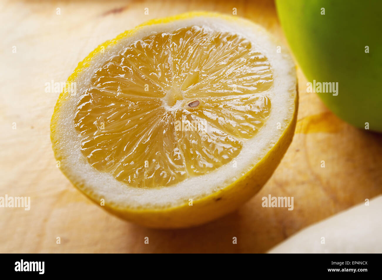 cut a lemon on old board Stock Photo - Alamy
