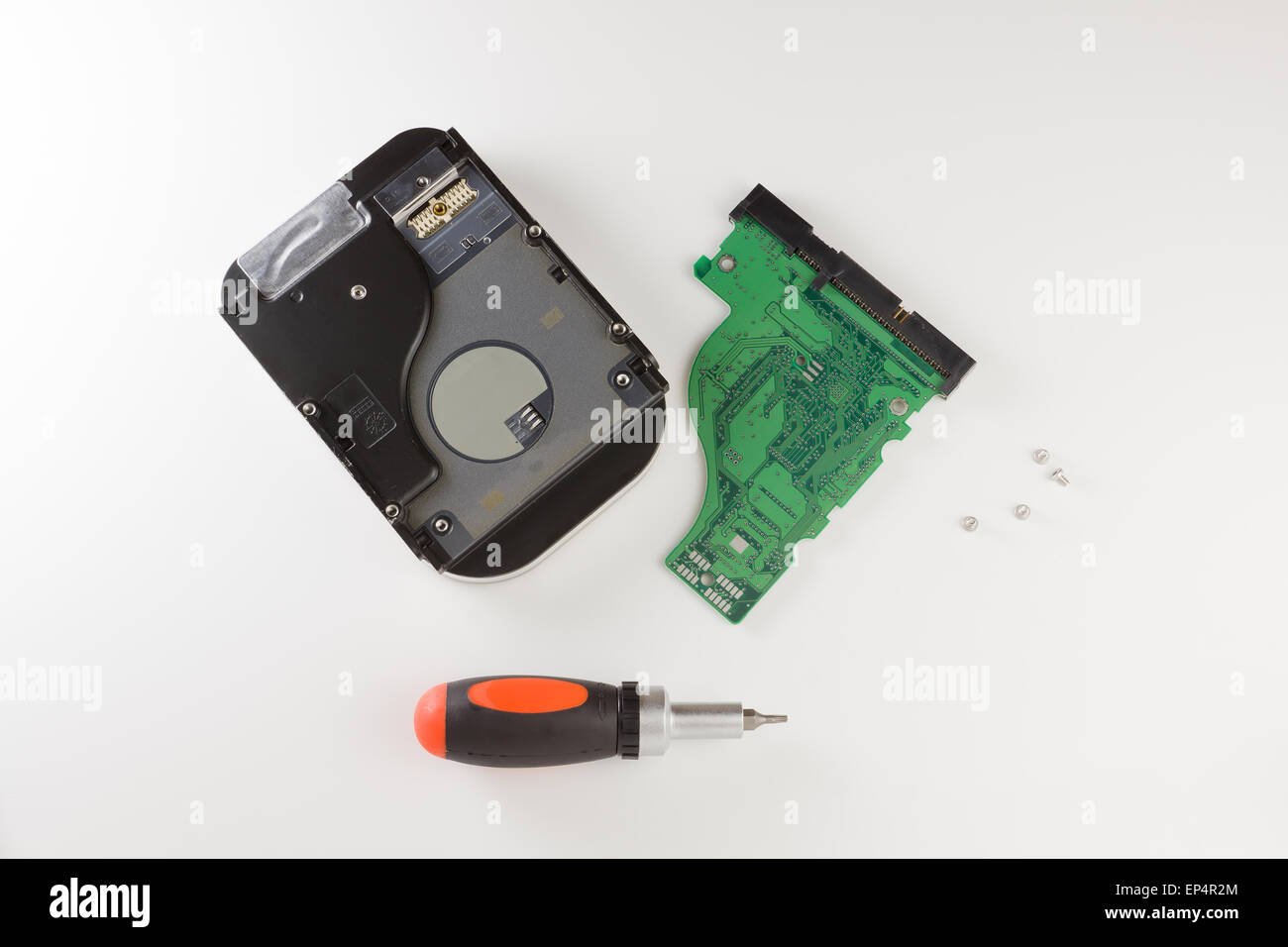 the computer hard drive in the course of dismantling on a white ...