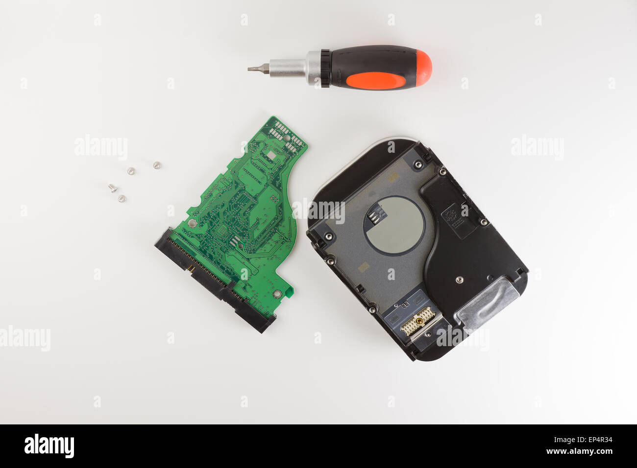 the computer hard drive in the course of dismantling on a white ...