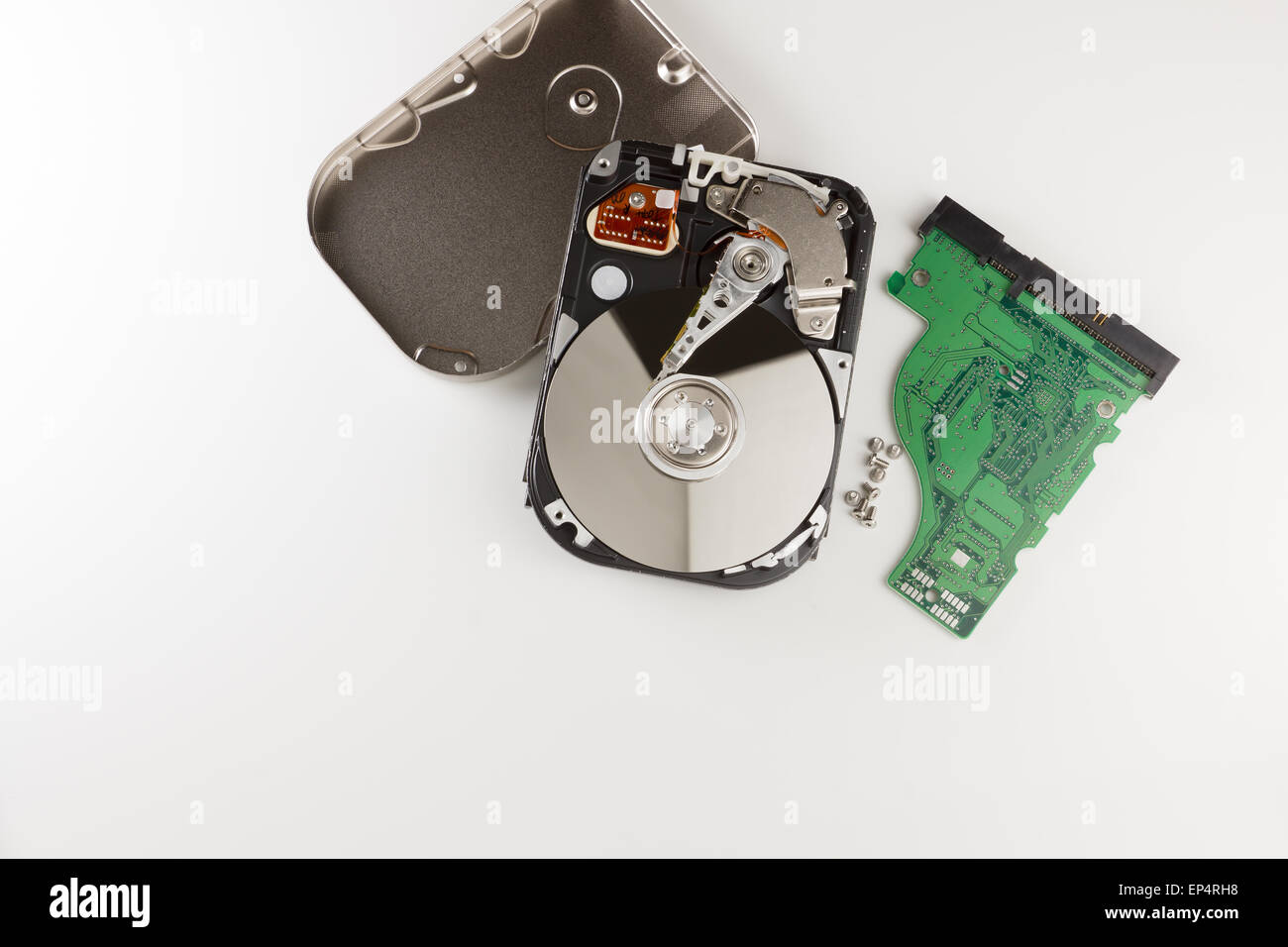 the computer hard drive in the course of dismantling on a white ...