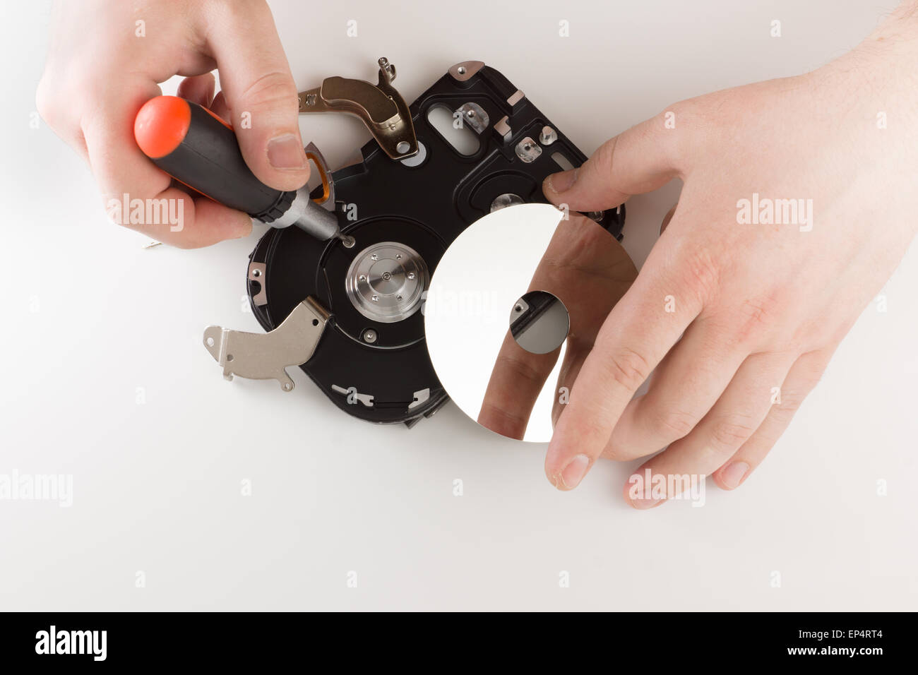 the computer hard drive in the course of dismantling on a white ...