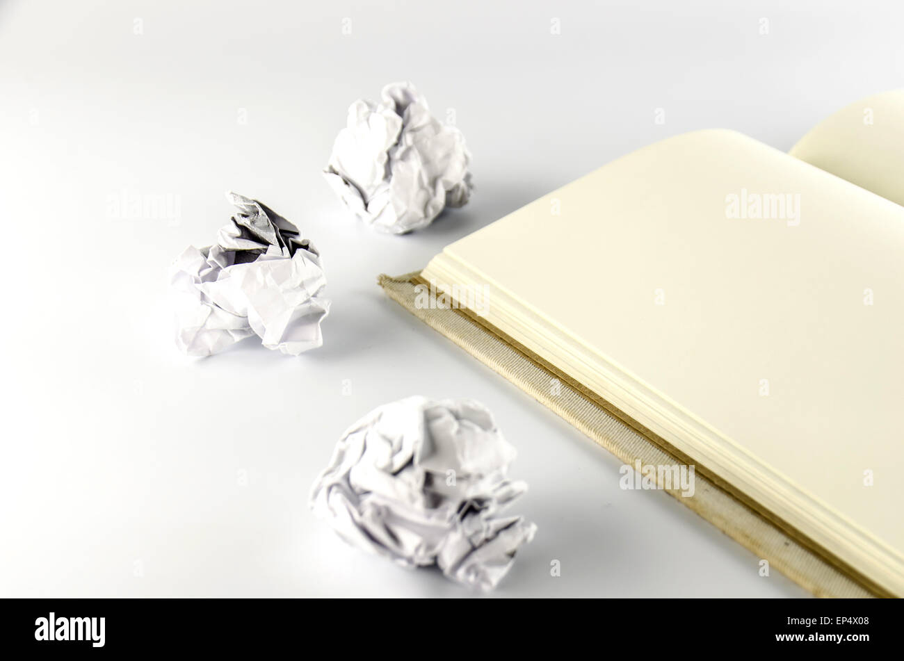 crumpled paper and notebook on a white background Stock Photo - Alamy