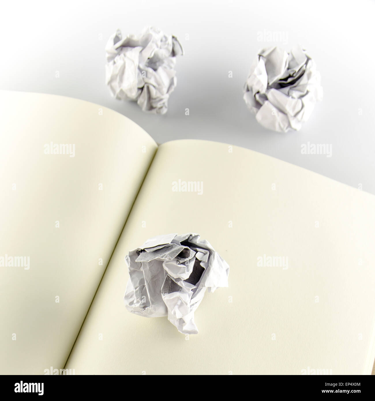 crumpled paper and notebook on a white background Stock Photo - Alamy