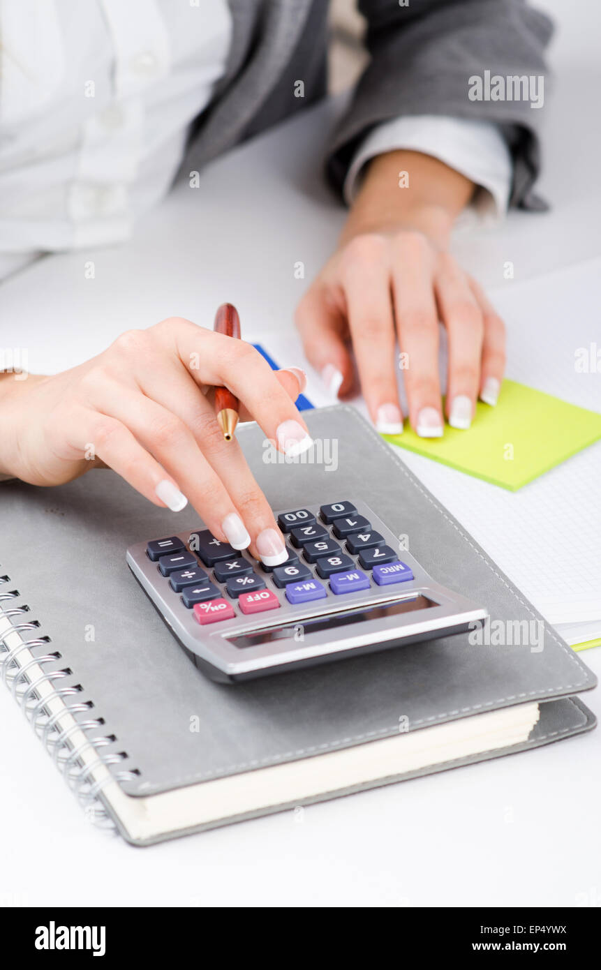 Hands working on the calculator Stock Photo - Alamy