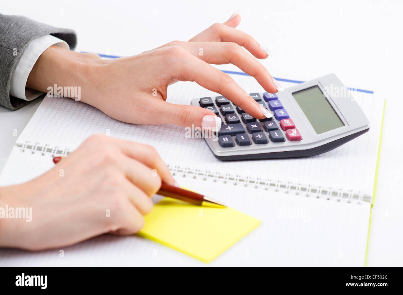 Hands working on the calculator Stock Photo - Alamy