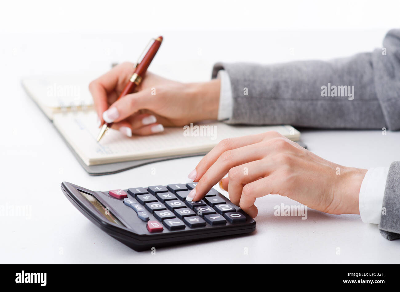 Hands working on the calculator Stock Photo - Alamy