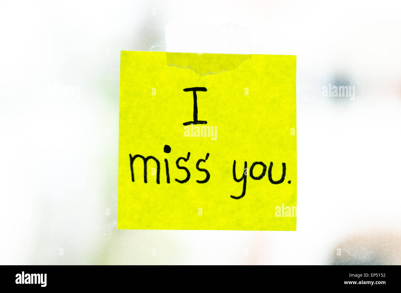 I miss you word sticky note on window mirror Stock Photo - Alamy