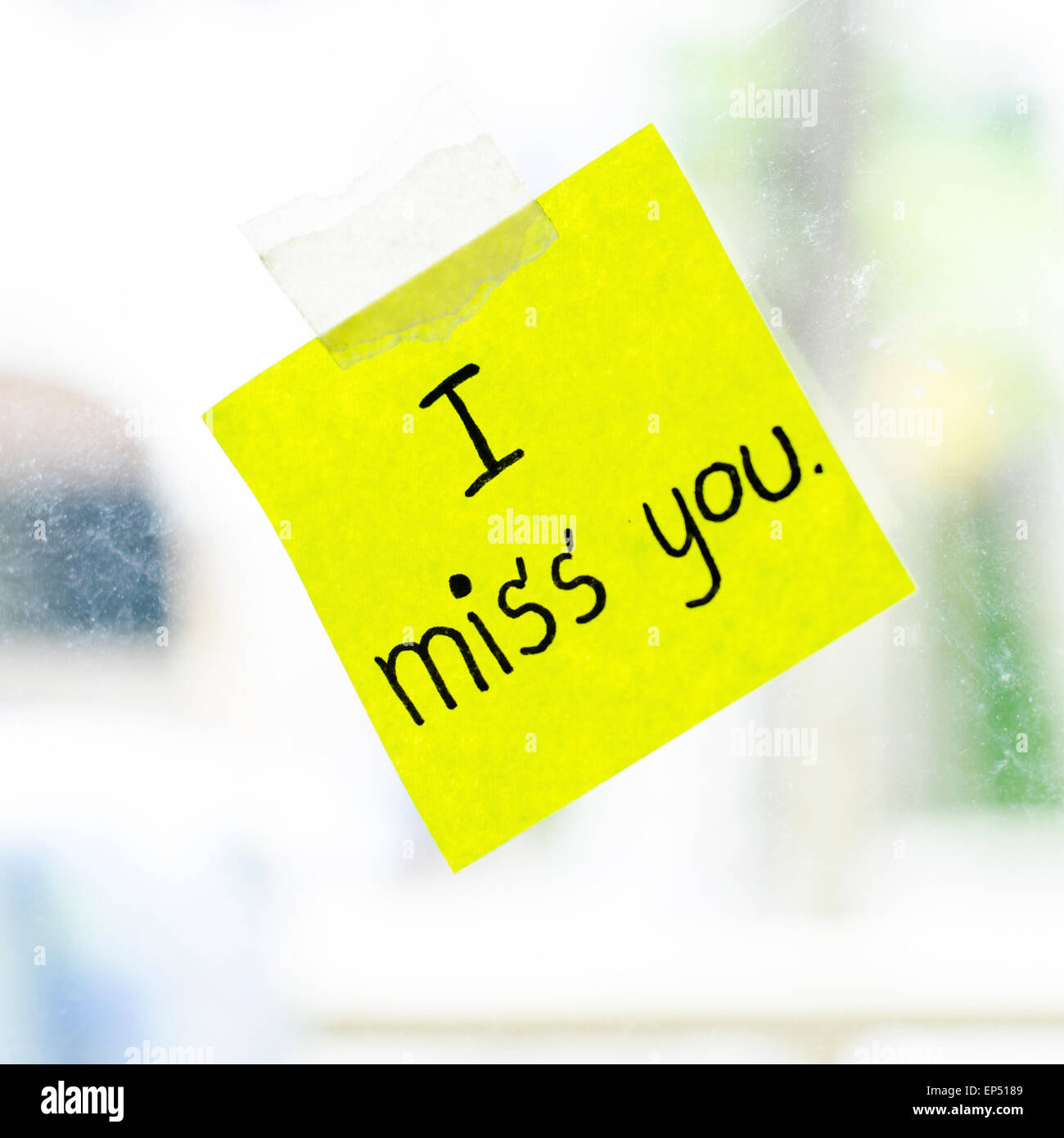 I miss you word sticky note on window mirror Stock Photo - Alamy