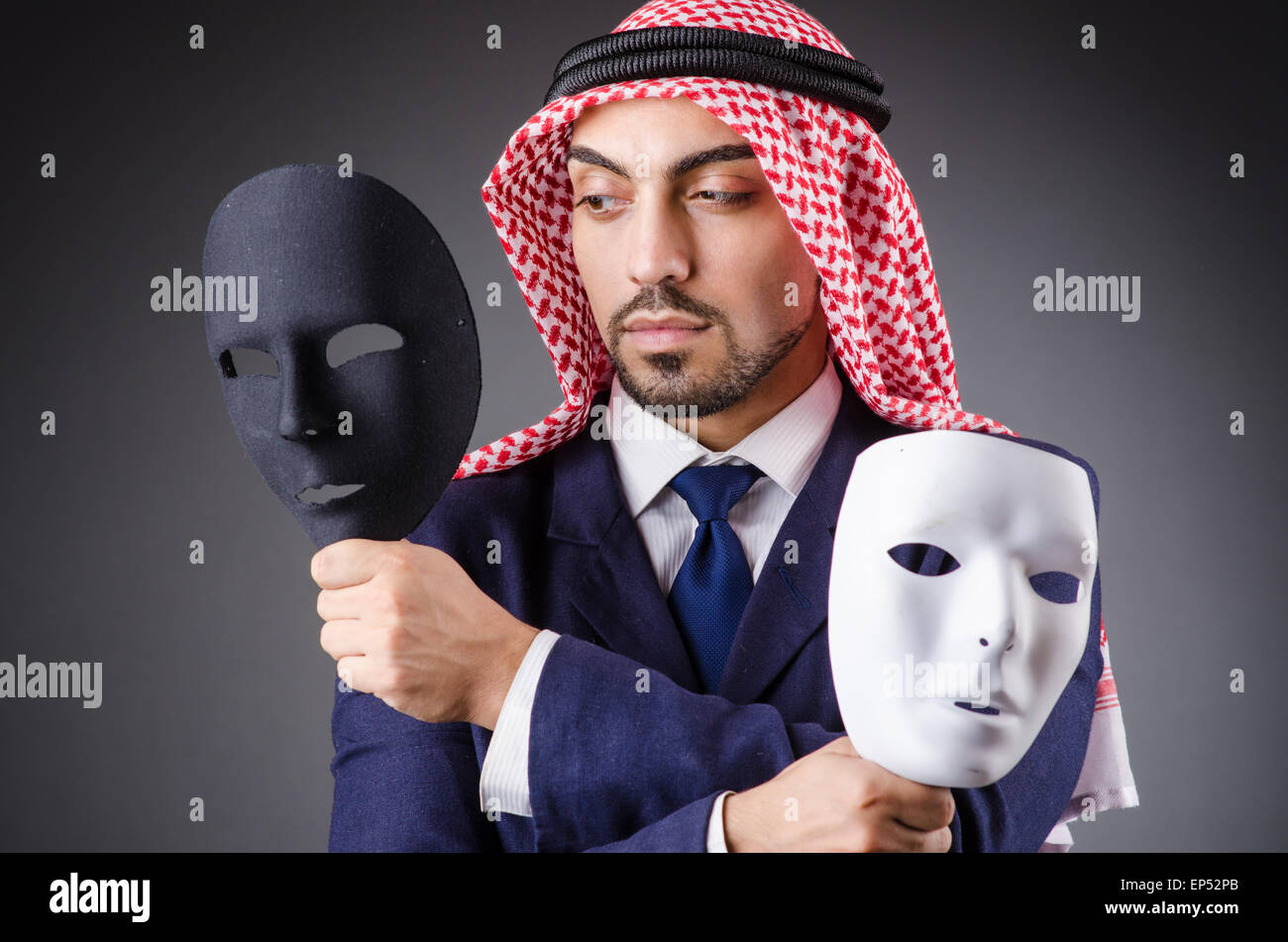 Arab with masks in dark studio Stock Photo - Alamy