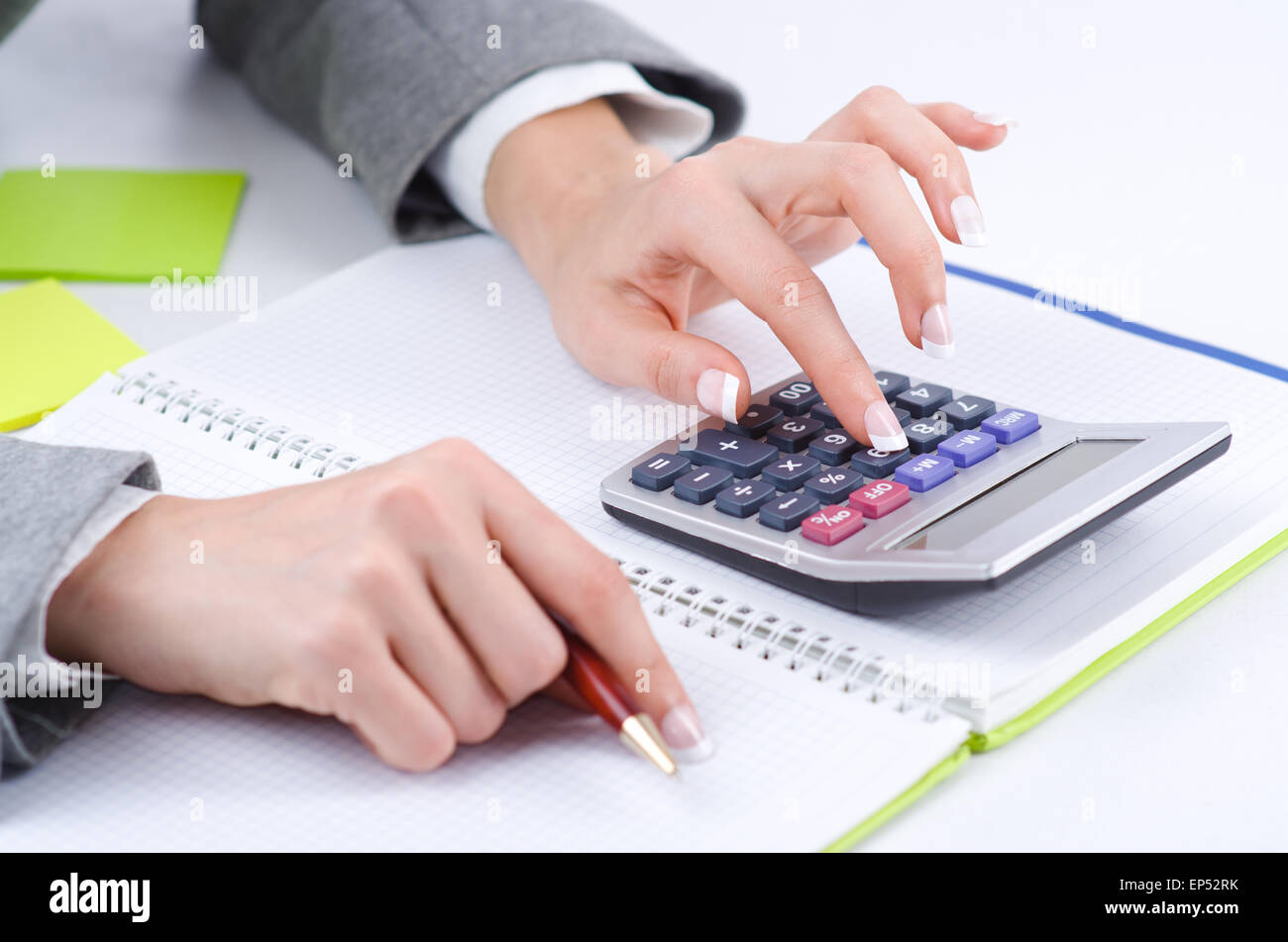Hands working on the calculator Stock Photo - Alamy