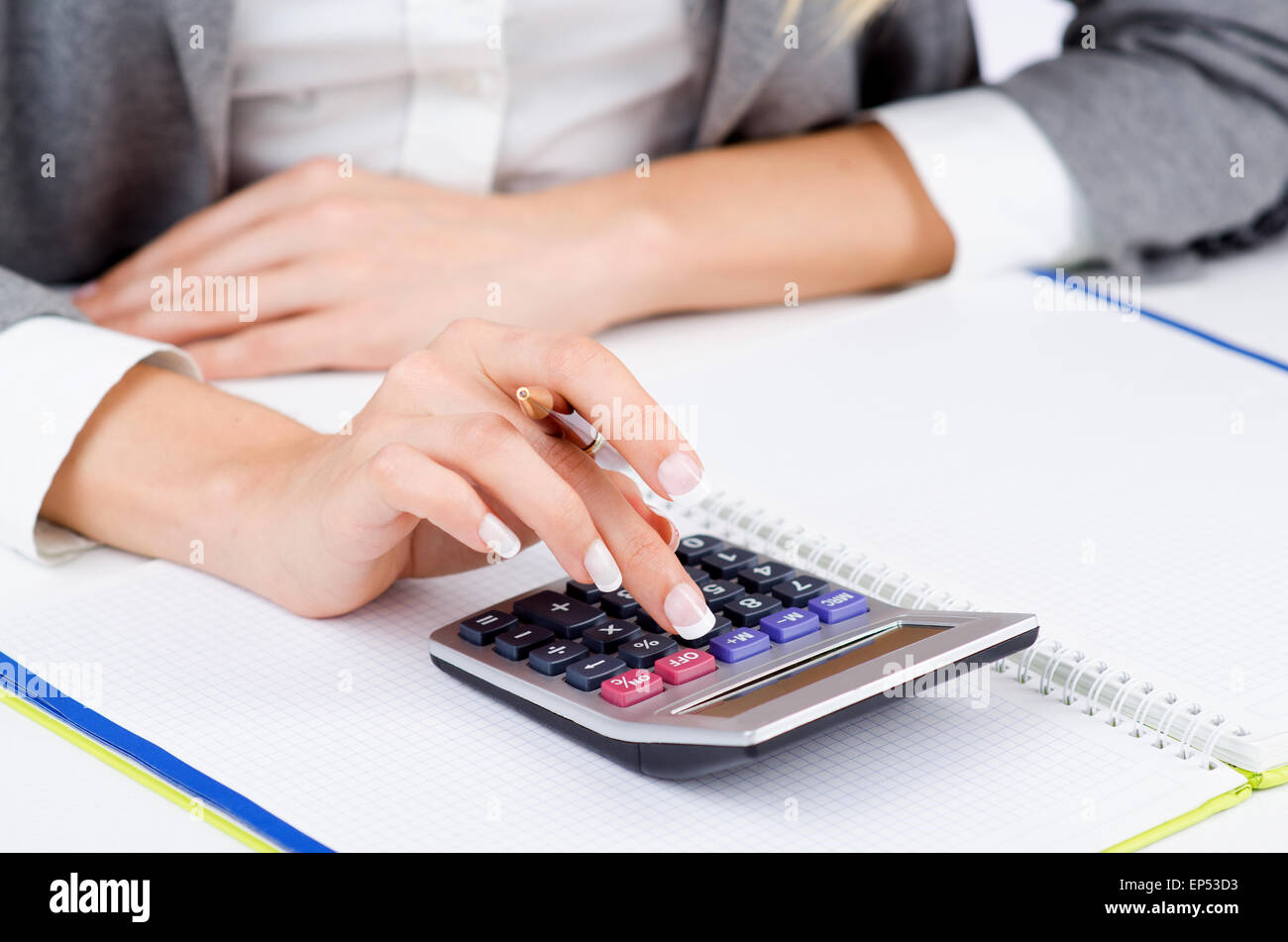 Hands working on the calculator Stock Photo - Alamy