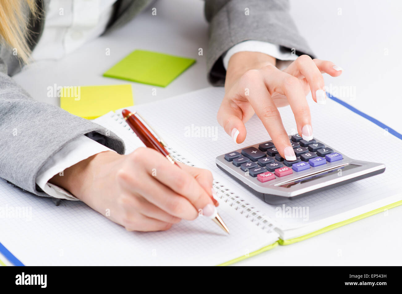 Hands working on the calculator Stock Photo - Alamy