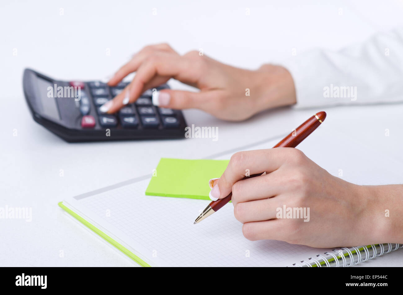 Hands working on the calculator Stock Photo - Alamy