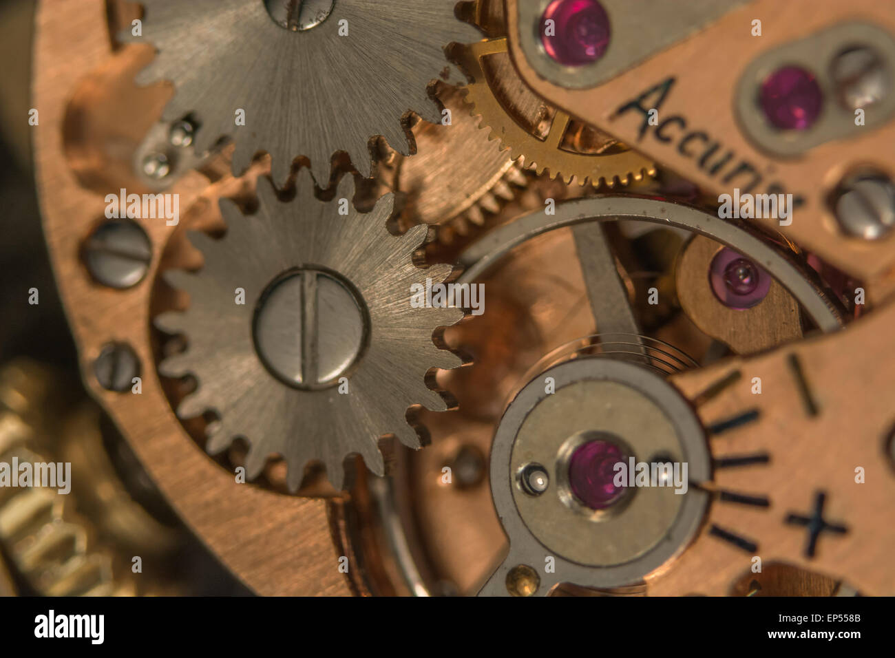 Macro-photo of wristwatch mechanism. Key focus on right hand teeth of ...