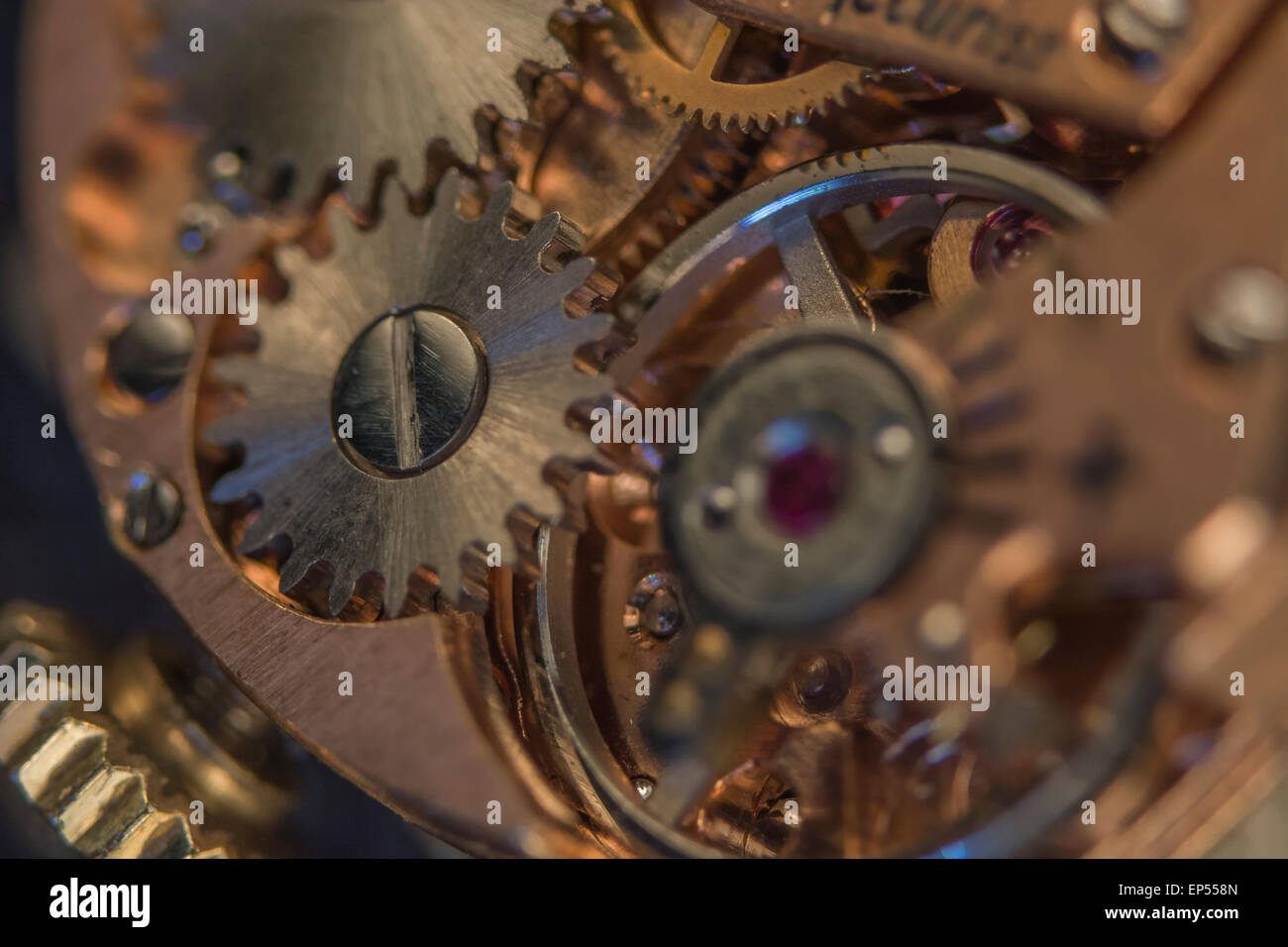 Macro-photo of wristwatch mechanism. Key focus on upper right hand ...