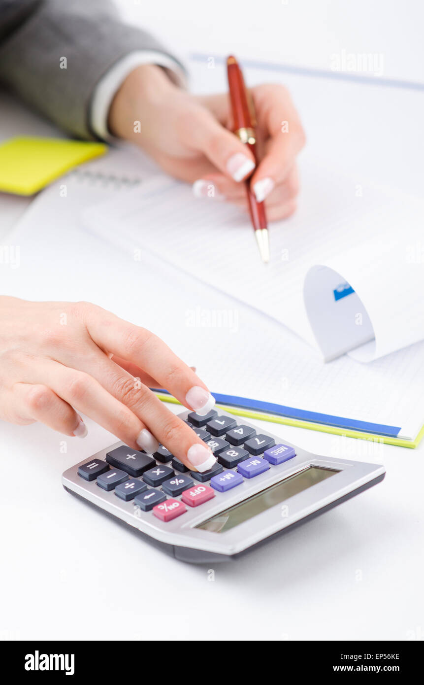 Hands working on the calculator Stock Photo - Alamy