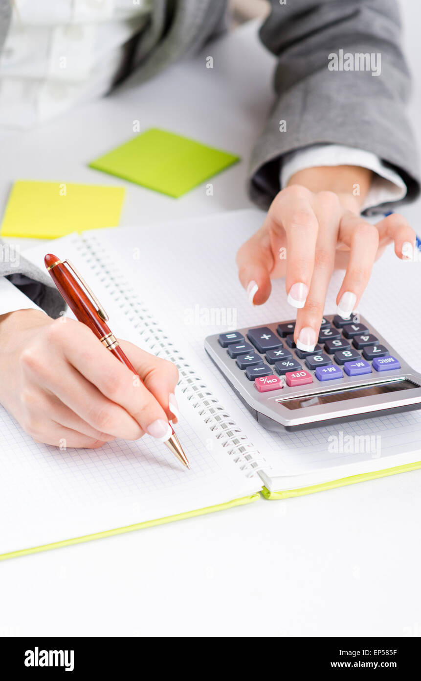 Hands working on the calculator Stock Photo - Alamy