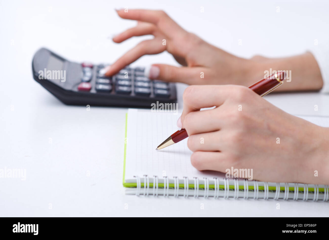 Hands working on the calculator Stock Photo - Alamy