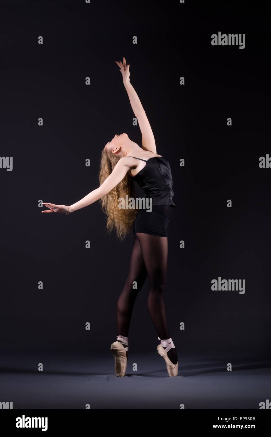 Ballerina dancing in the dark studio Stock Photo - Alamy
