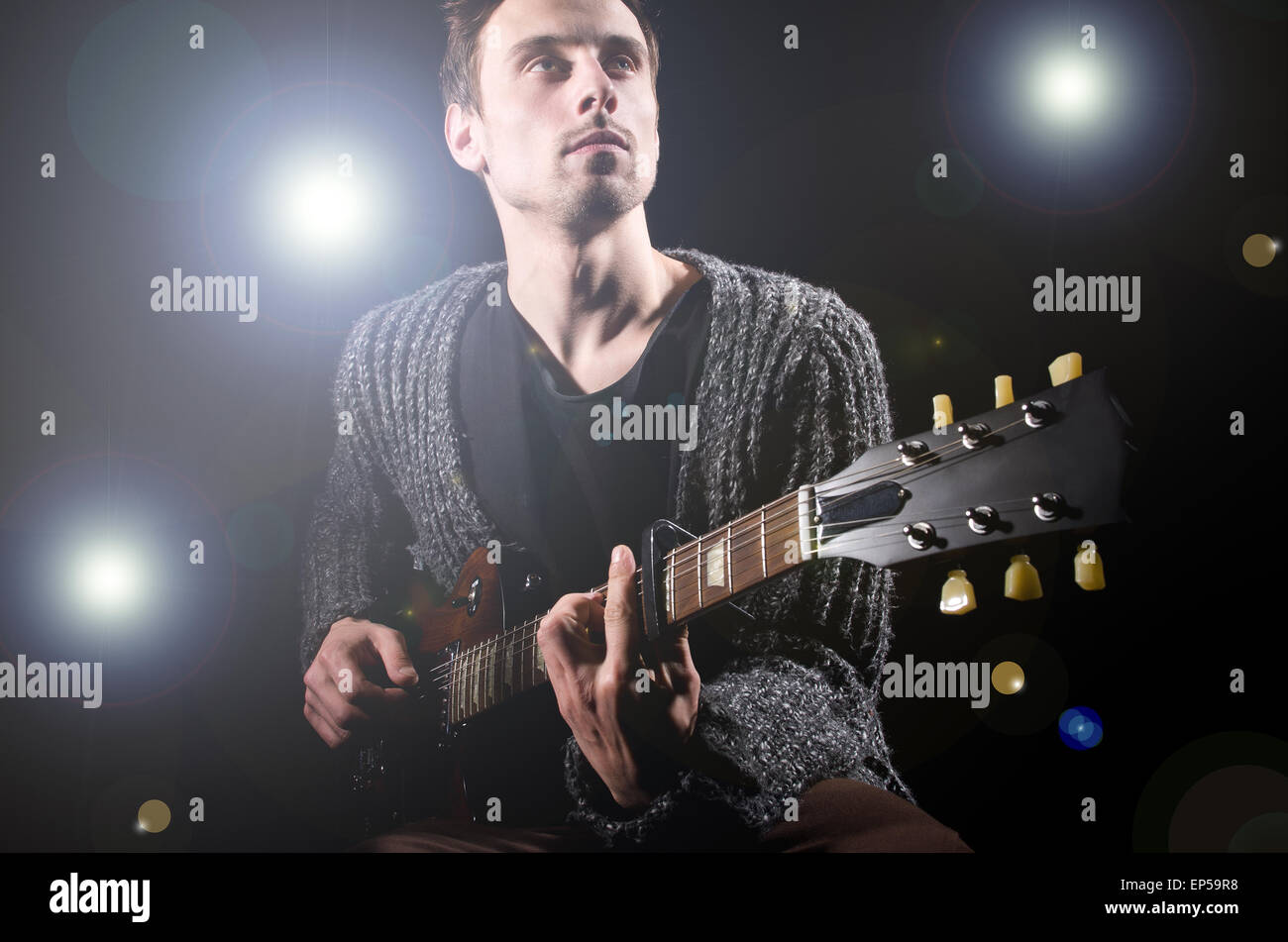 Man playing guitar during concert Stock Photo - Alamy
