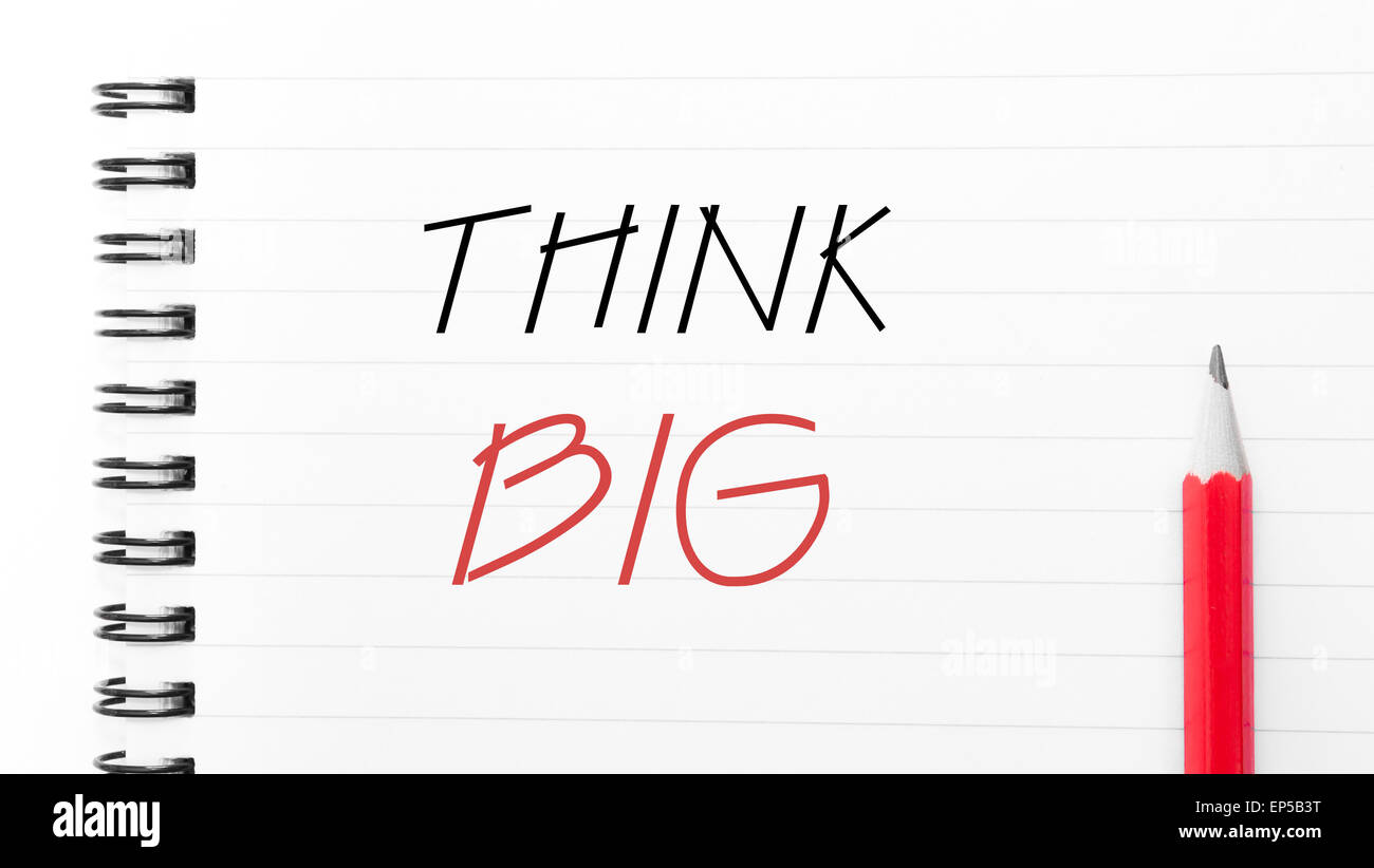 Think Big Text written on notebook page, red pencil on the right ...