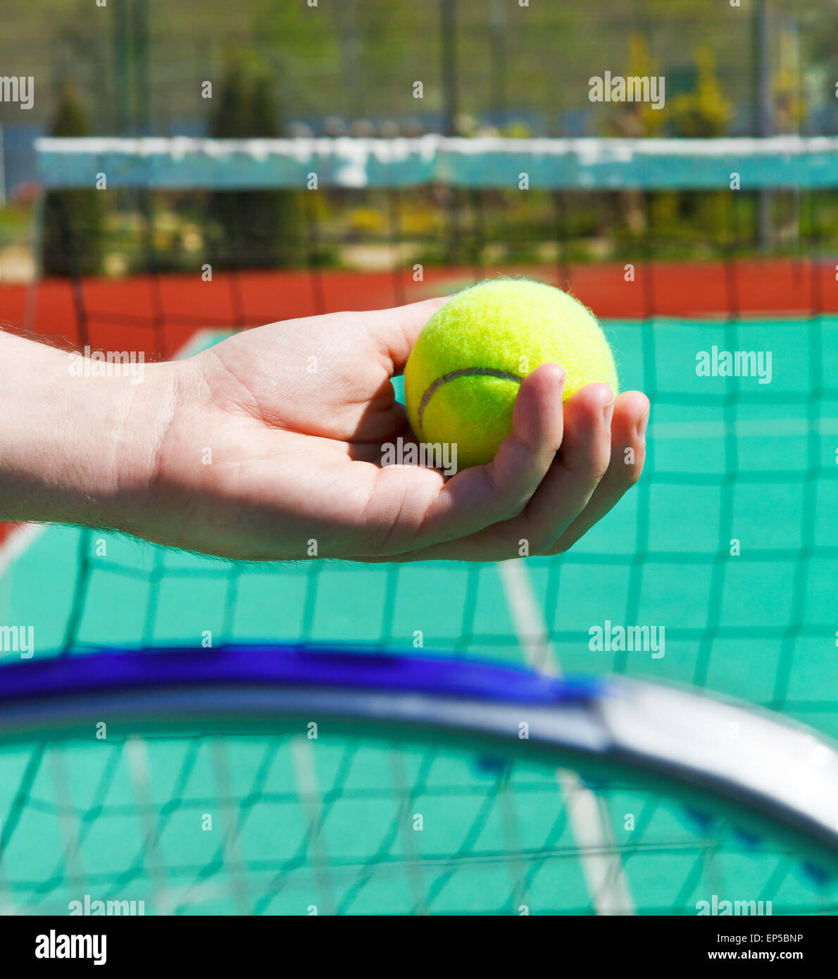 Close up of tennis racquet and ball in hands Stock Photo - Alamy