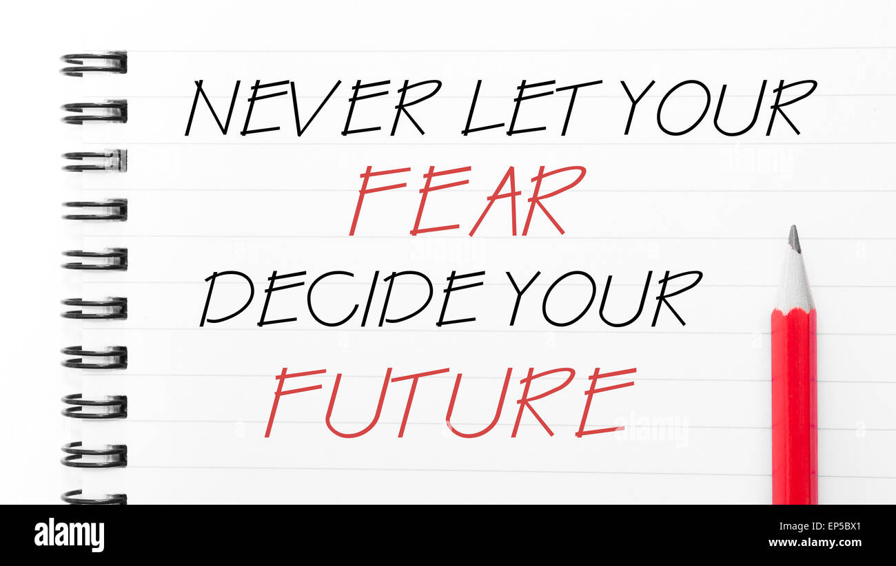 Never Let Your Fear Decide Your Future Text written on notebook page ...