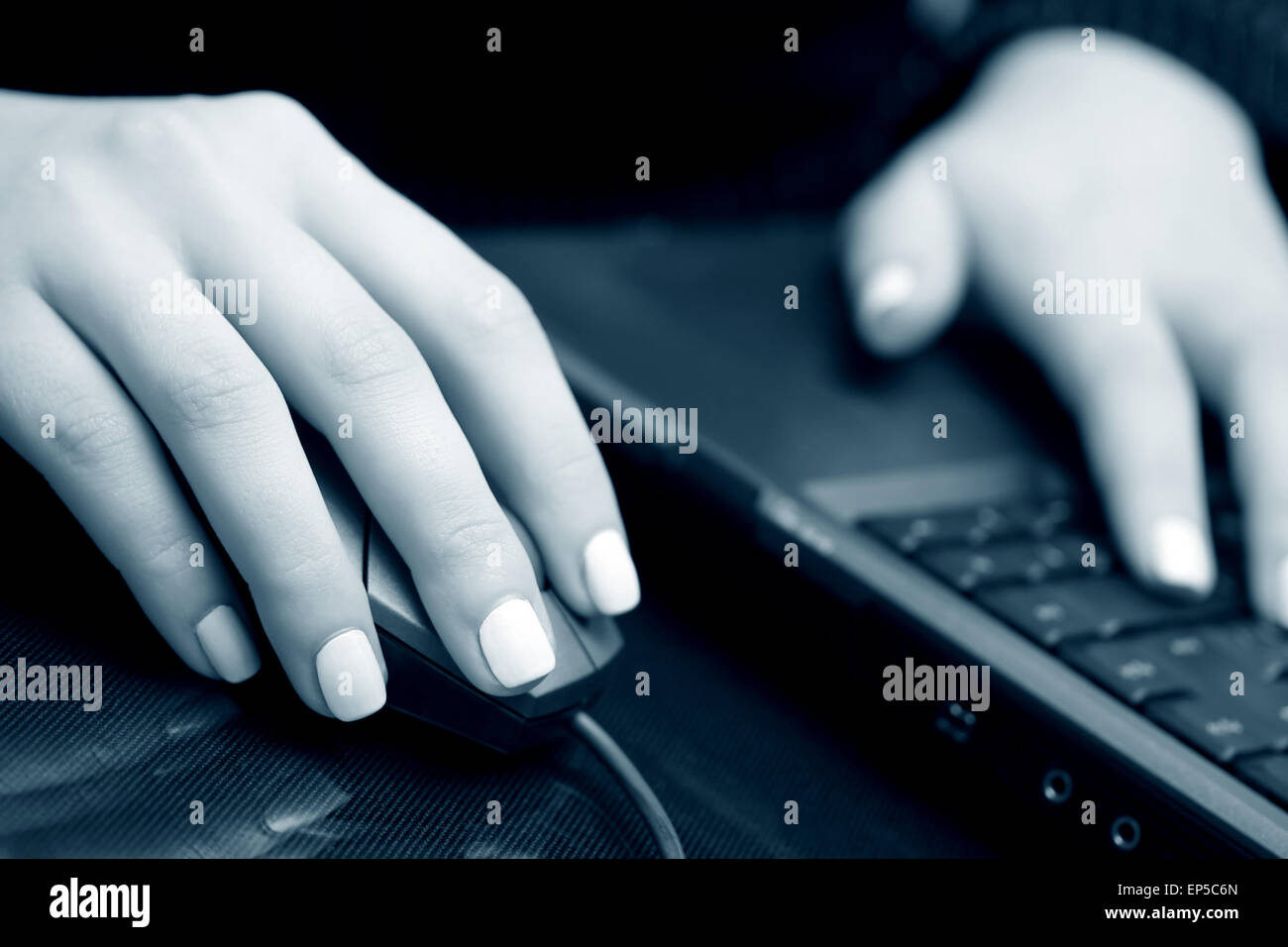 Female hands using computer mouse and keyboard Stock Photo - Alamy