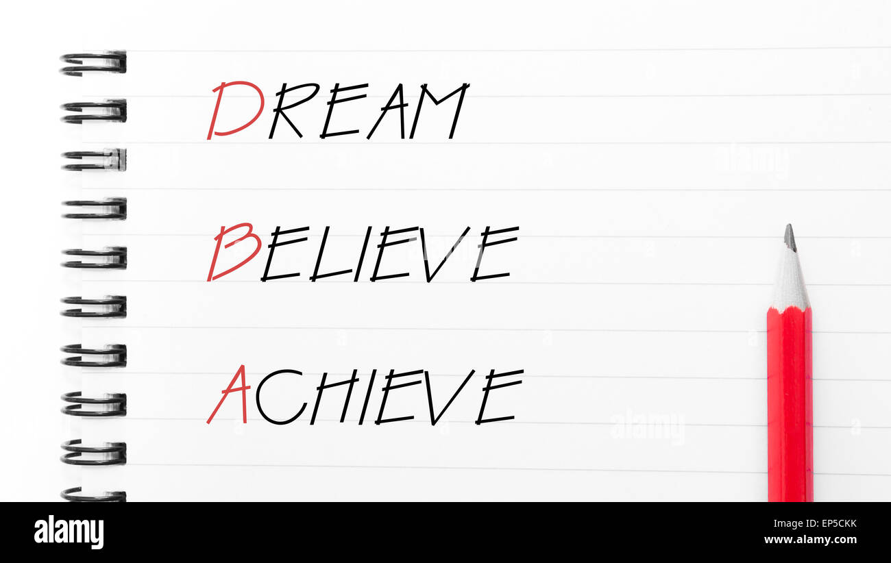 Dream, Believe, Achieve Text written on notebook page, red pencil on ...