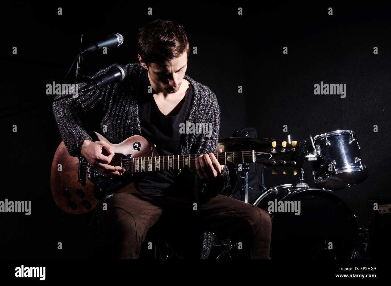 Man playing guitar during concert Stock Photo - Alamy